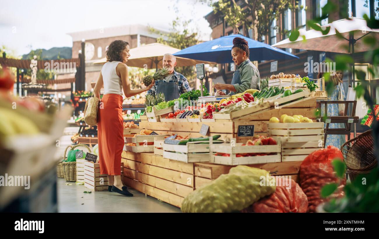 Hispanic Female Customer Buying Two Garlic Heads and a Pineapple From a ...