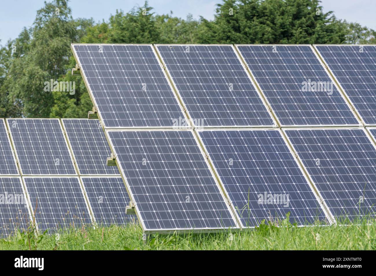 Sections of racked fixed tilt PV / Photo-voltaic solar farm array of ...