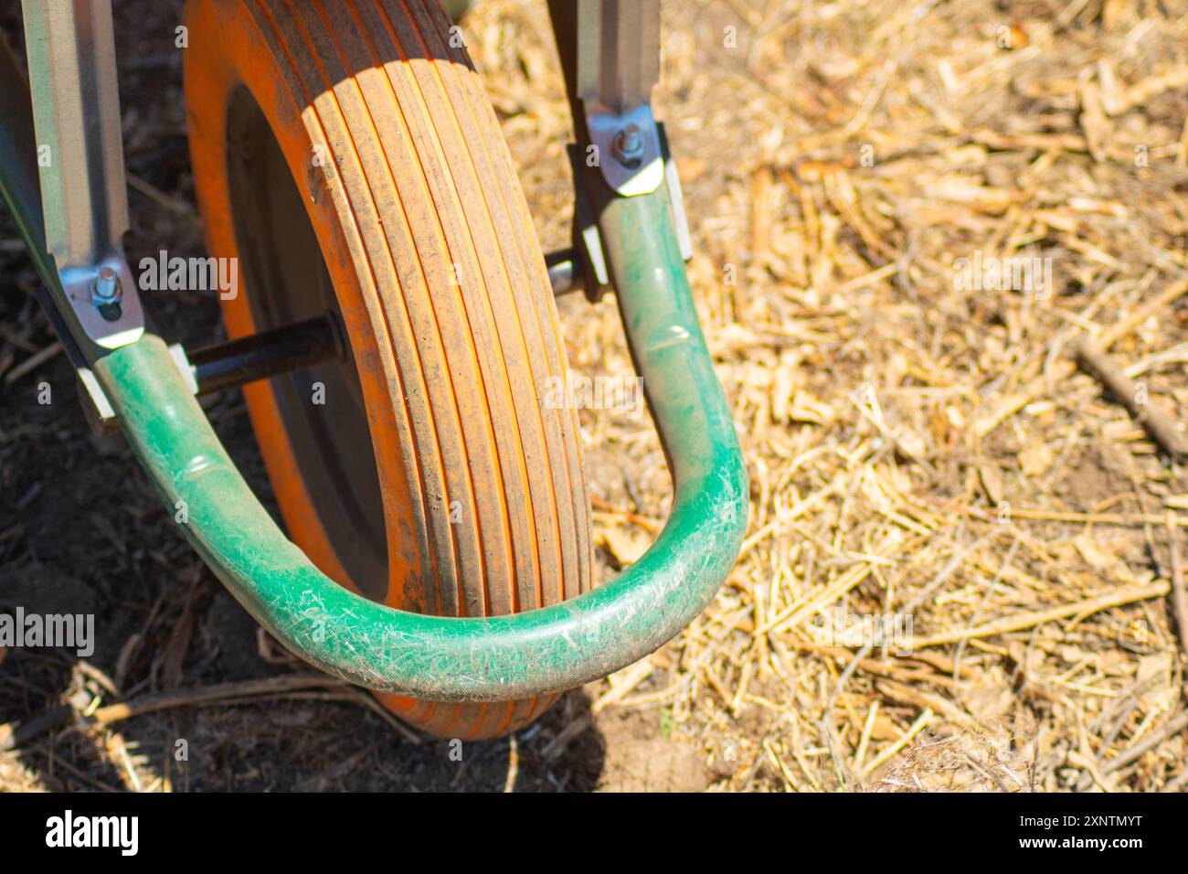 close-up of a yellow and green wheelbarrow wheel Stock Photo - Alamy