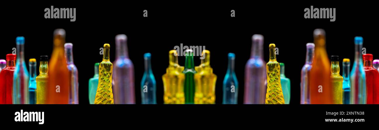 various miniature bottles of alcohol without labels with black ...