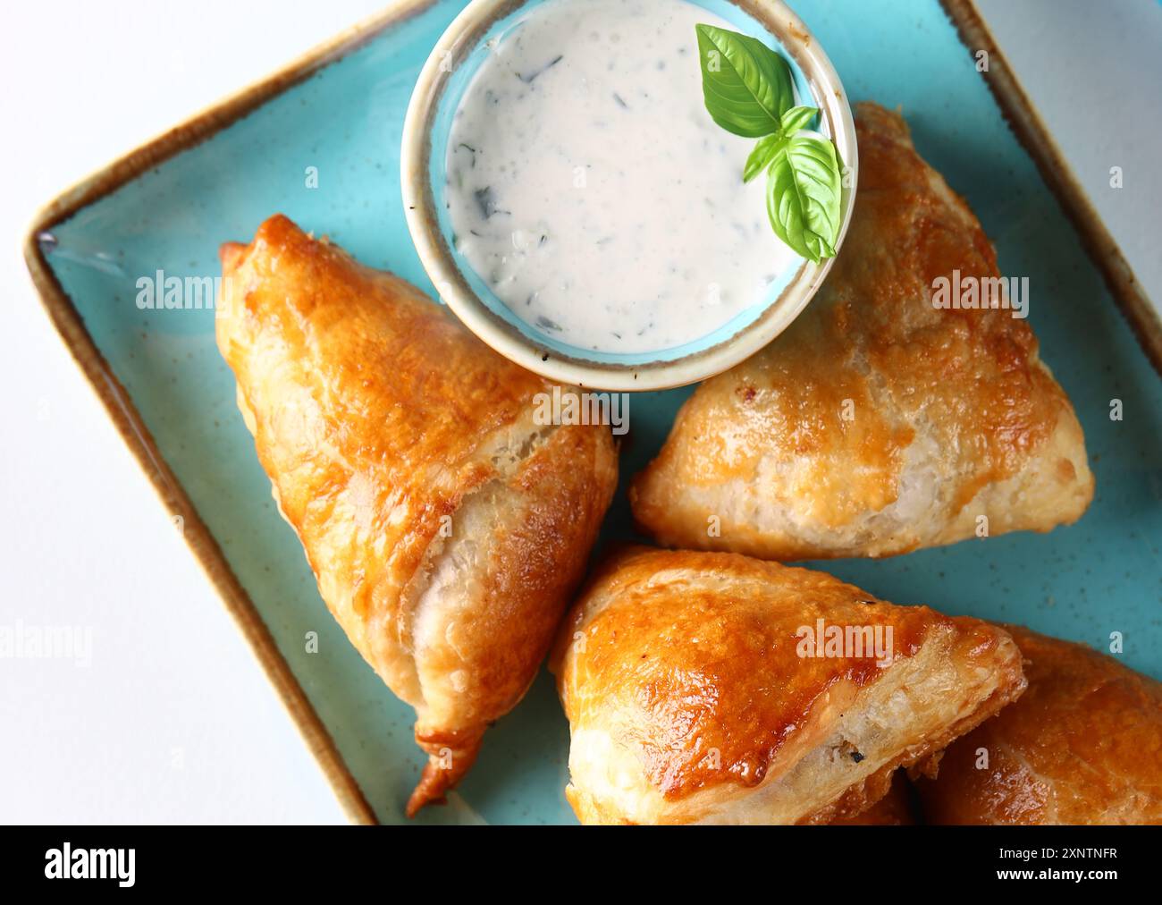 mini samsa snack pies with sauce Stock Photo - Alamy