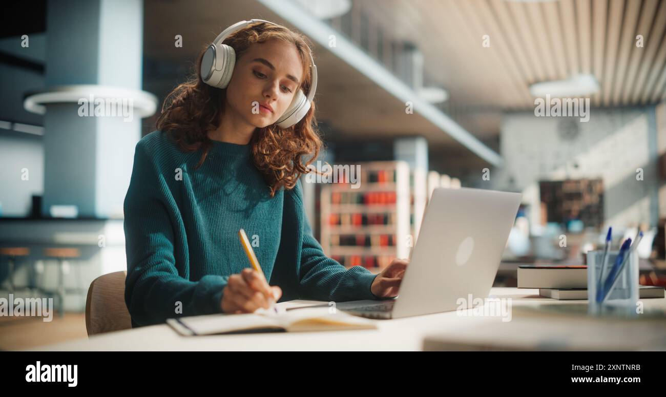 Concentrated Young Female Student Engaged in Academic Research With ...