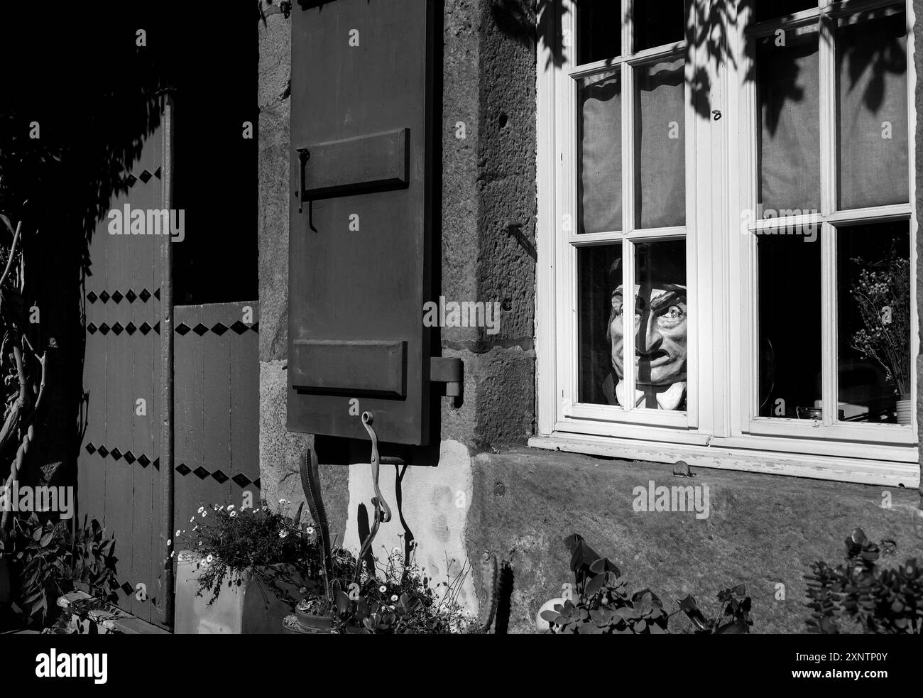 Mysterious doll peeking out from a window. Monochrome picture Stock ...