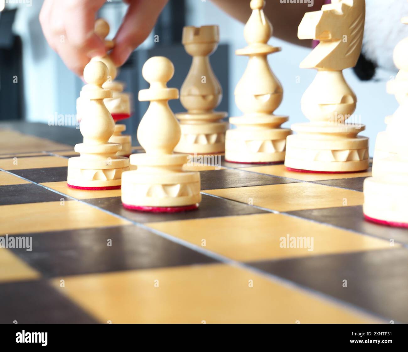 A close-up of chess with white pawns human hand Stock Photo - Alamy