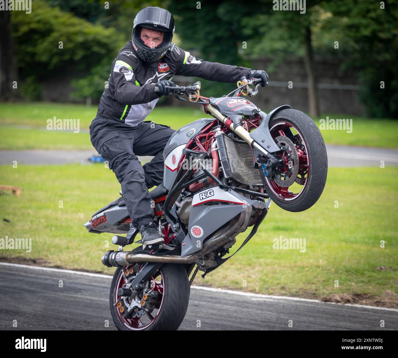 Motorcycle stunt rider pulling tricks Stock Photo - Alamy
