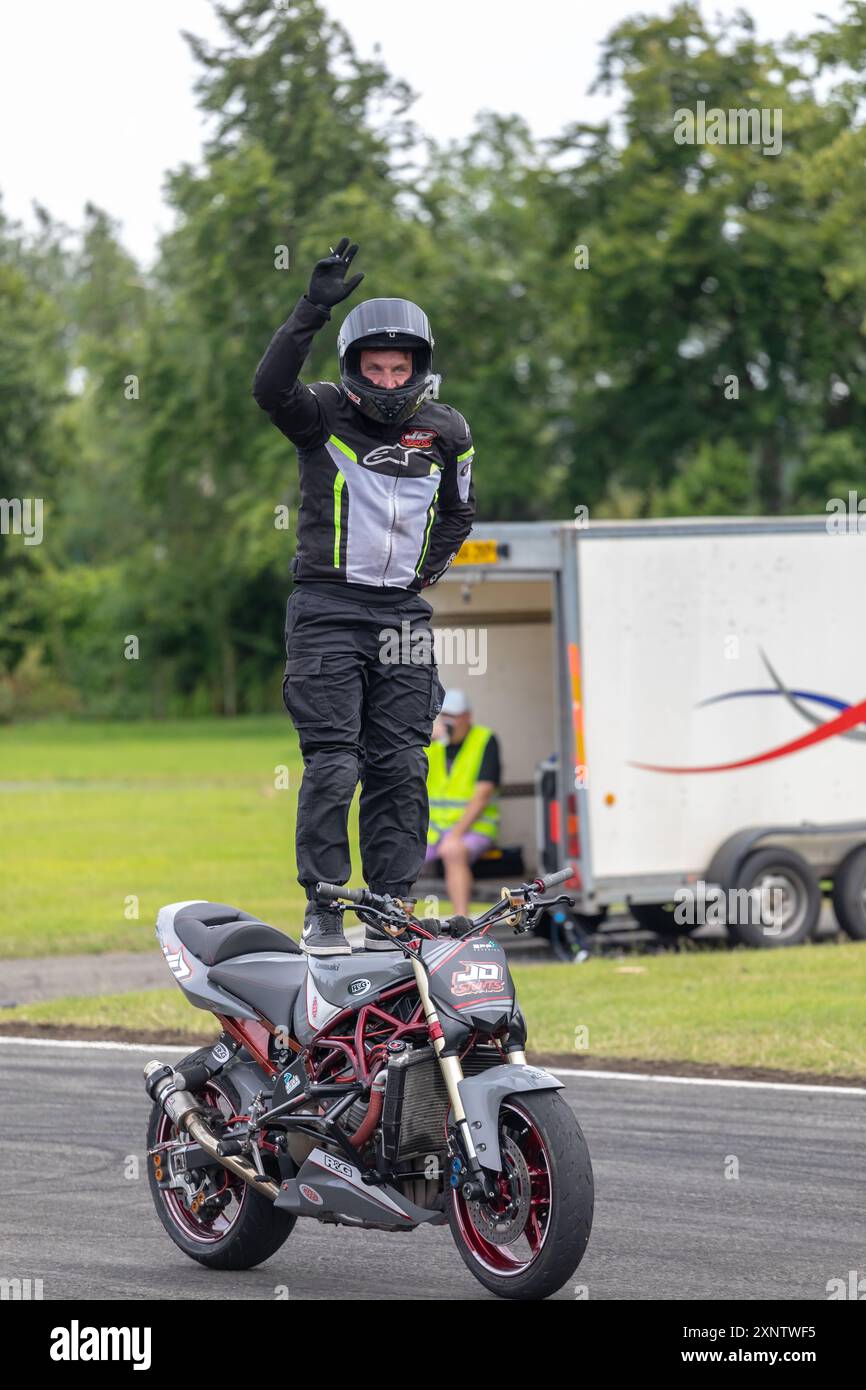 Motorcycle stunt rider pulling tricks Stock Photo - Alamy