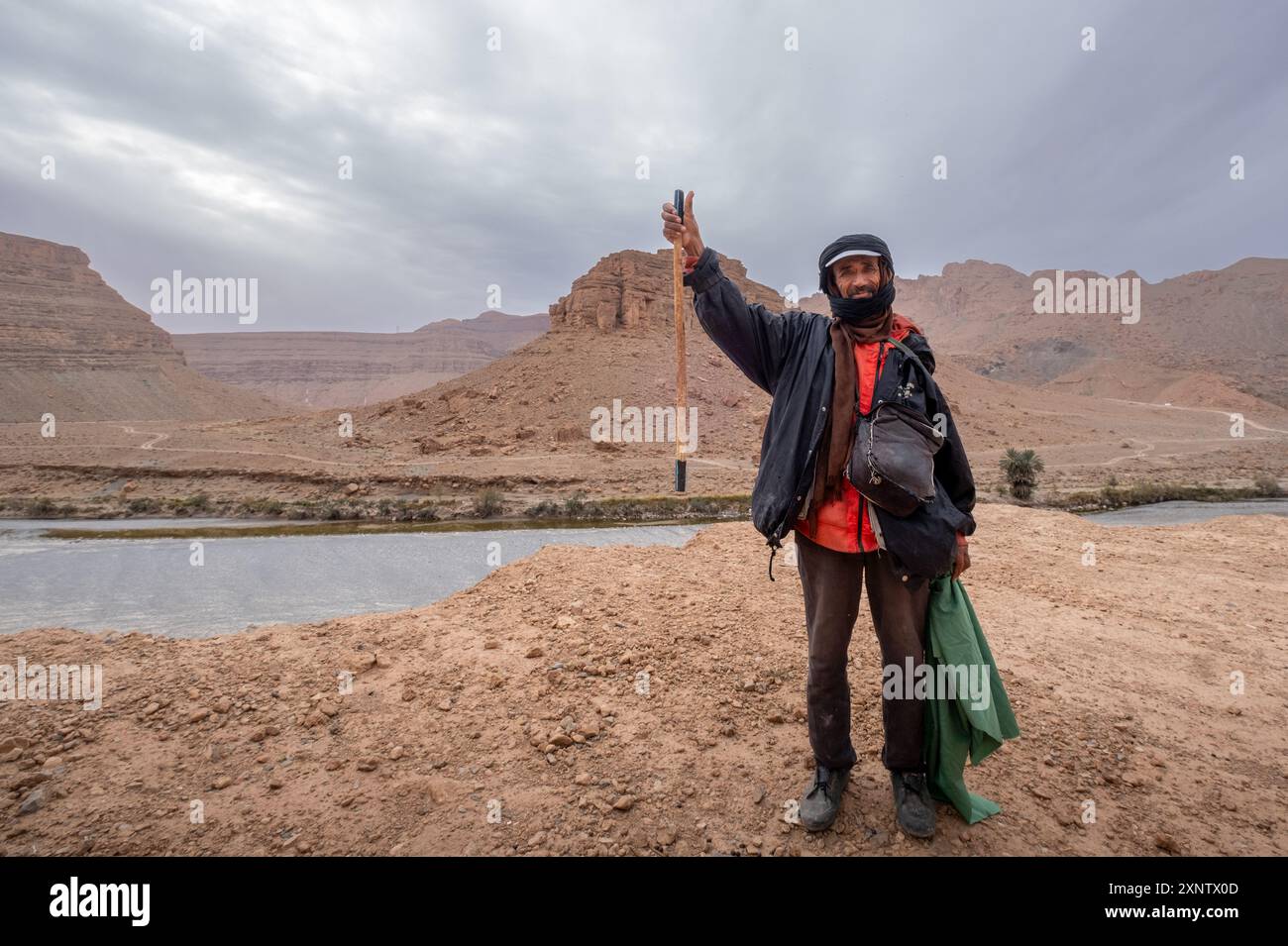A goat shepherd proudly salutes with his satchel and staff in the ...
