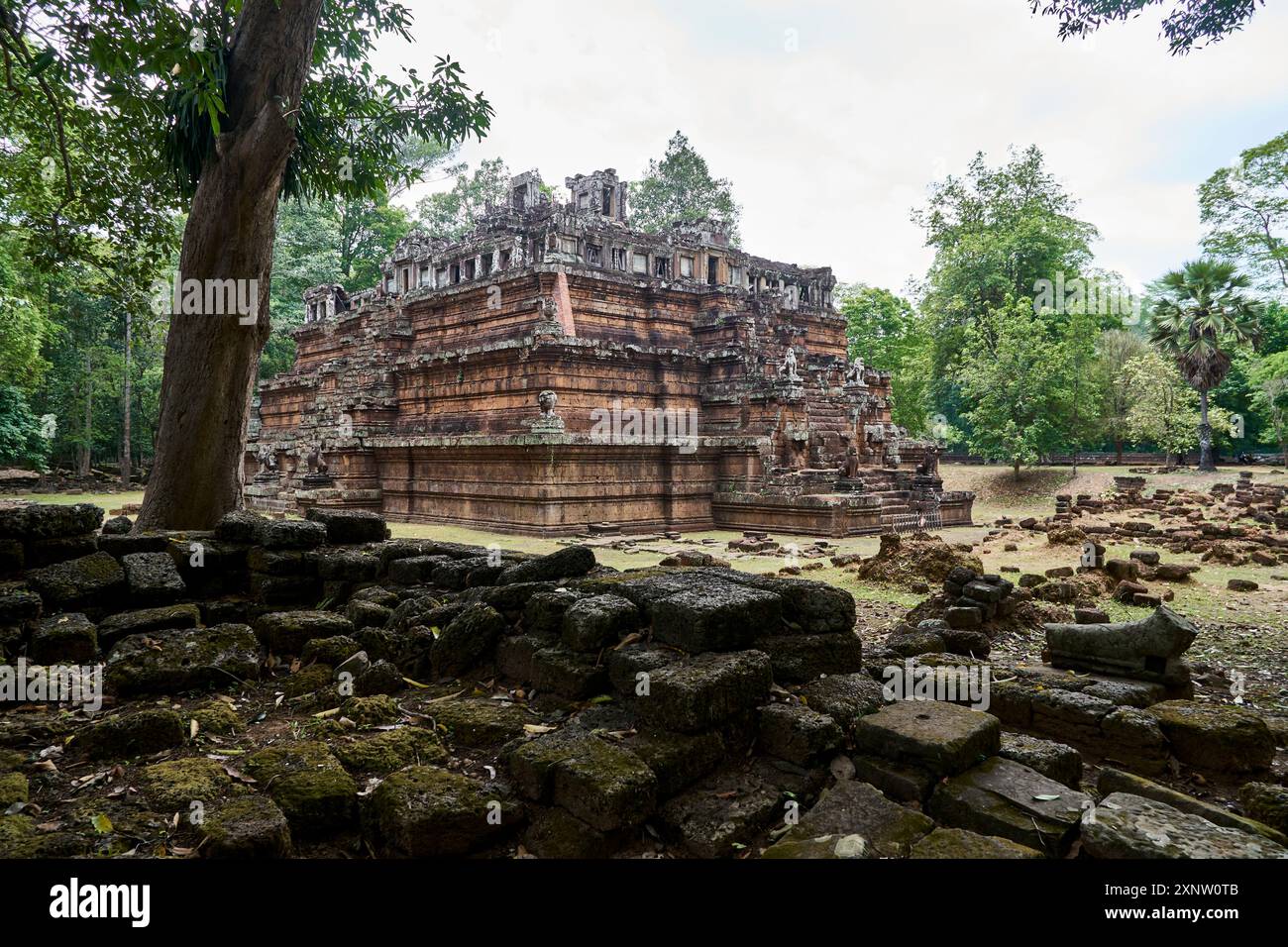 Ancient ruins of Angkor Thom temple in Cambodia with lush green trees ...