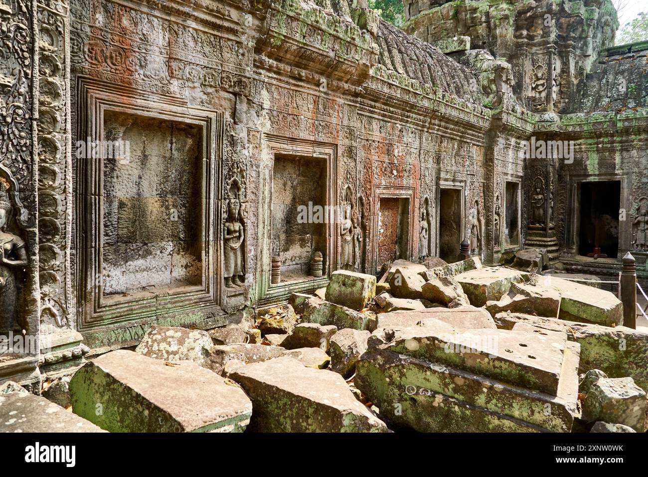 View of the ancient stone ruins and detailed carvings at Angkor Thom ...