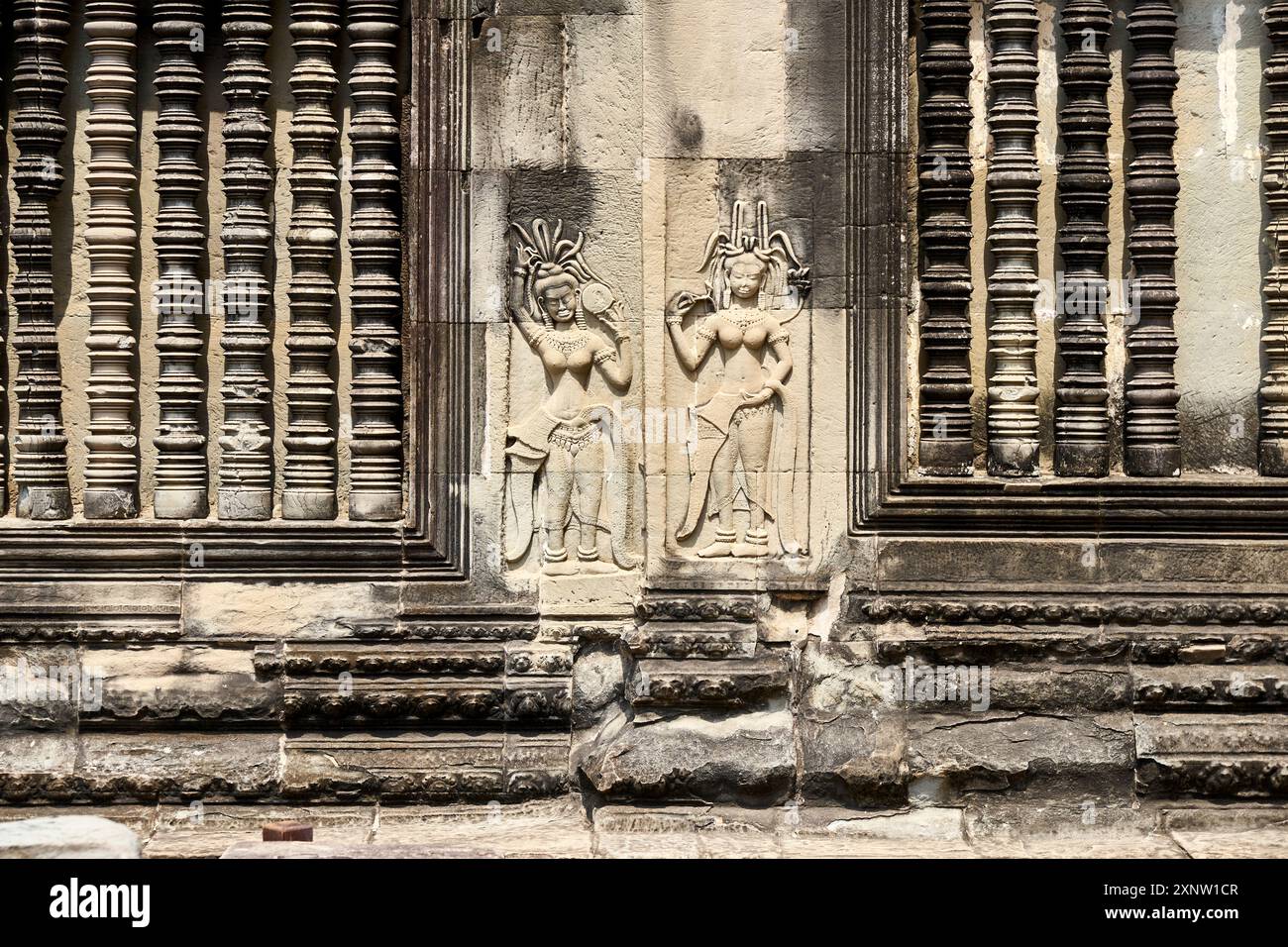 Detailed stone carvings of beautiful figures at the ancient Angkor Wat ...