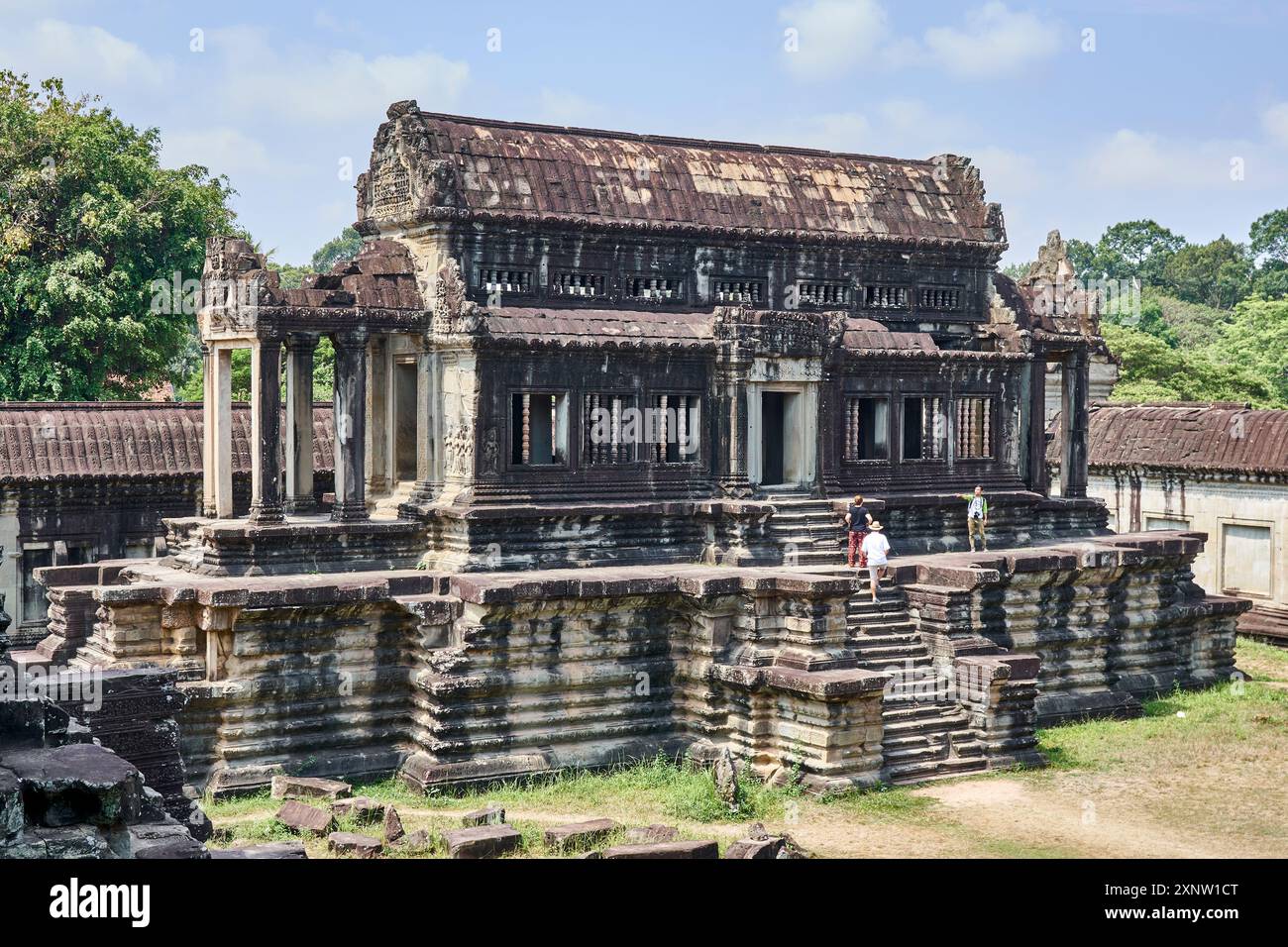 Tourists exploring the ancient Angkor Wat temple ruins in Cambodia. The ...