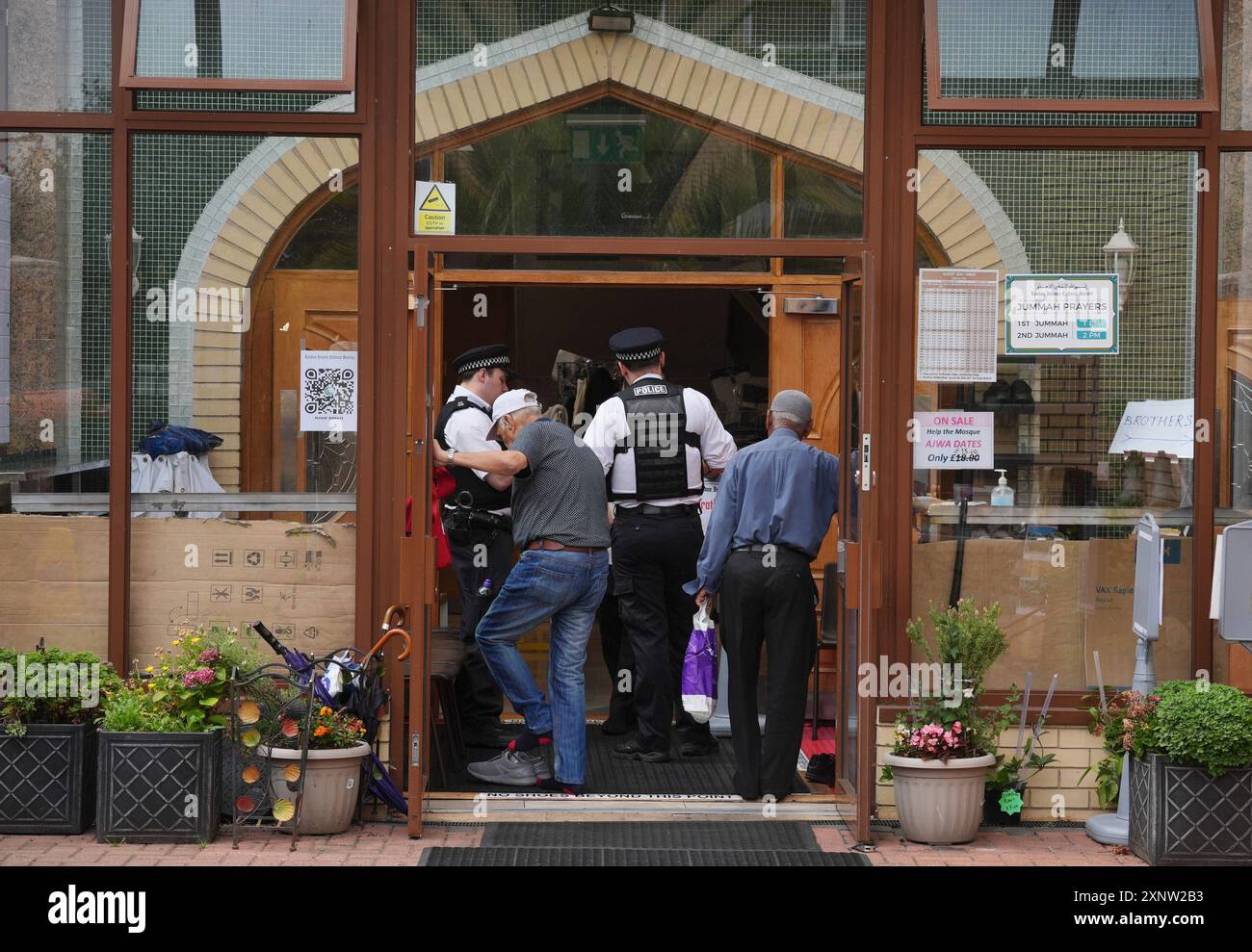 Police officers at the London Islamic Cultural Society (LICS) and ...