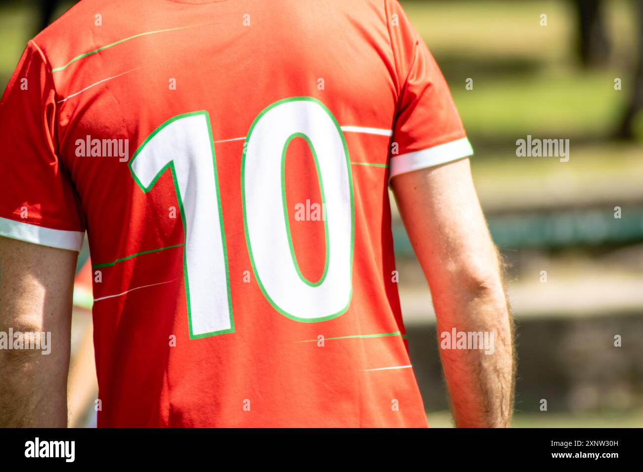 unrecognizable football player seen from behind with a red shirt with ...