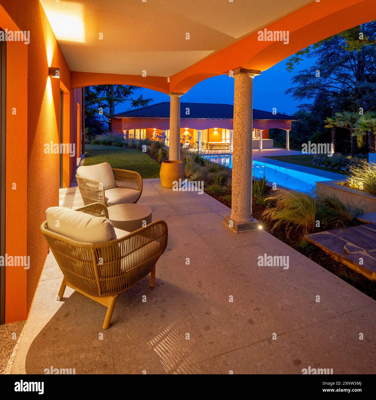 Outside patio with granite columns and two chairs. In the background ...