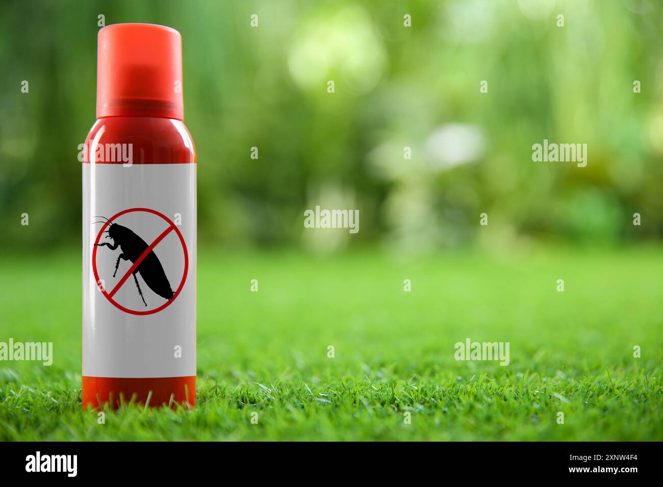 Insect repellent in spray can on green grass outdoors. Space for text ...