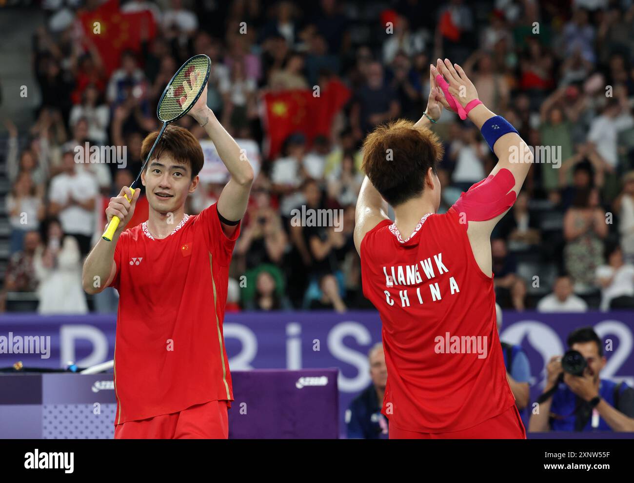 Paris, France. 2nd Aug, 2024. Liang Weikeng/Wang Chang (L) of China gesture after the men's ...
