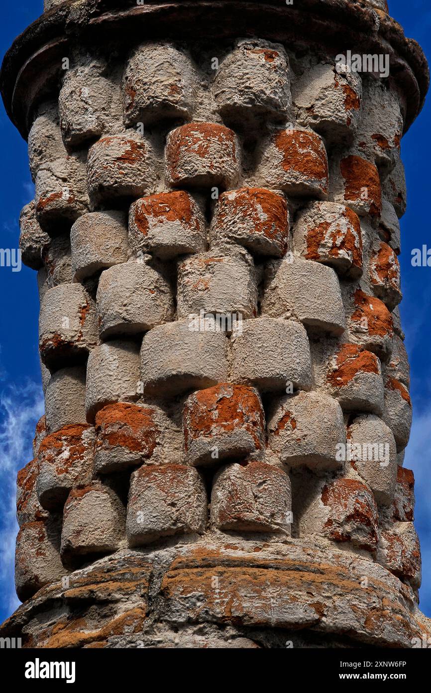 Finial of rounded bricks at corner of stone wall surrounding the ...
