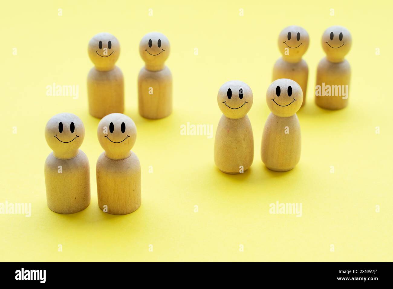 Wooden figure smiling in front of camera representing customer ...