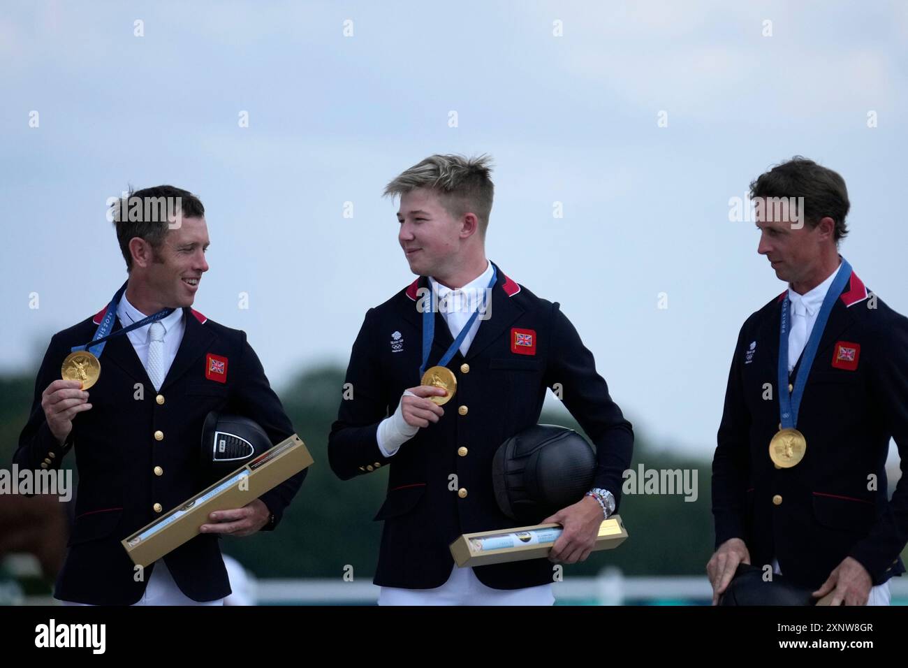 Britain's Scott Brash, left, Harry Charles, center, and Ben Maher show ...