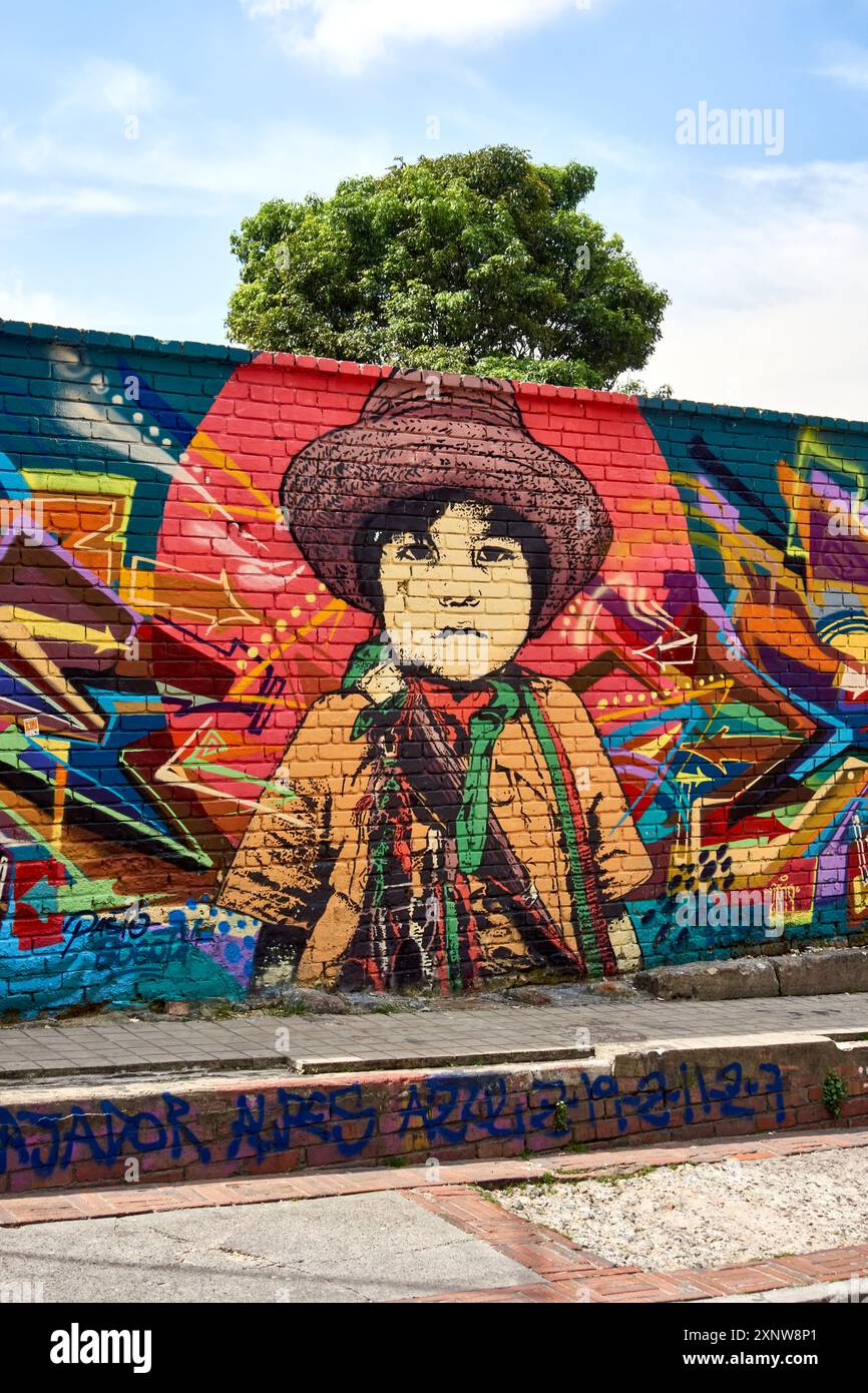 Colorful graffiti mural of a child wearing a hat, painted on a brick ...