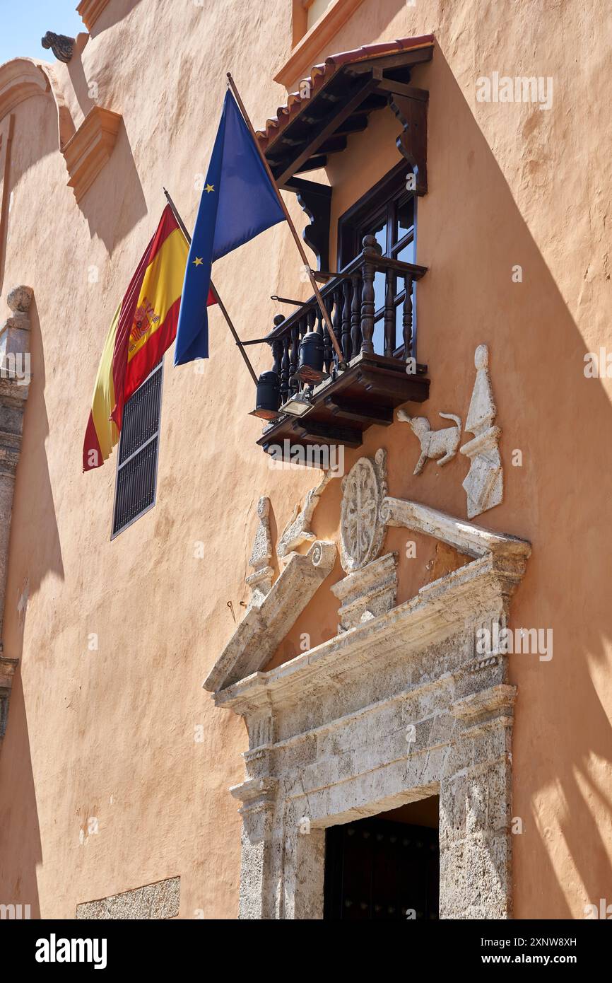 Historic building with a detailed facade, balcony, and flags of Spain ...
