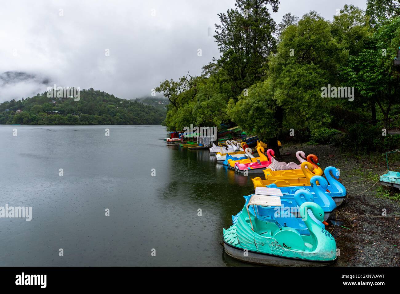 Empty boats lined up on the lakeside at Naukuchiatal Lake during the ...