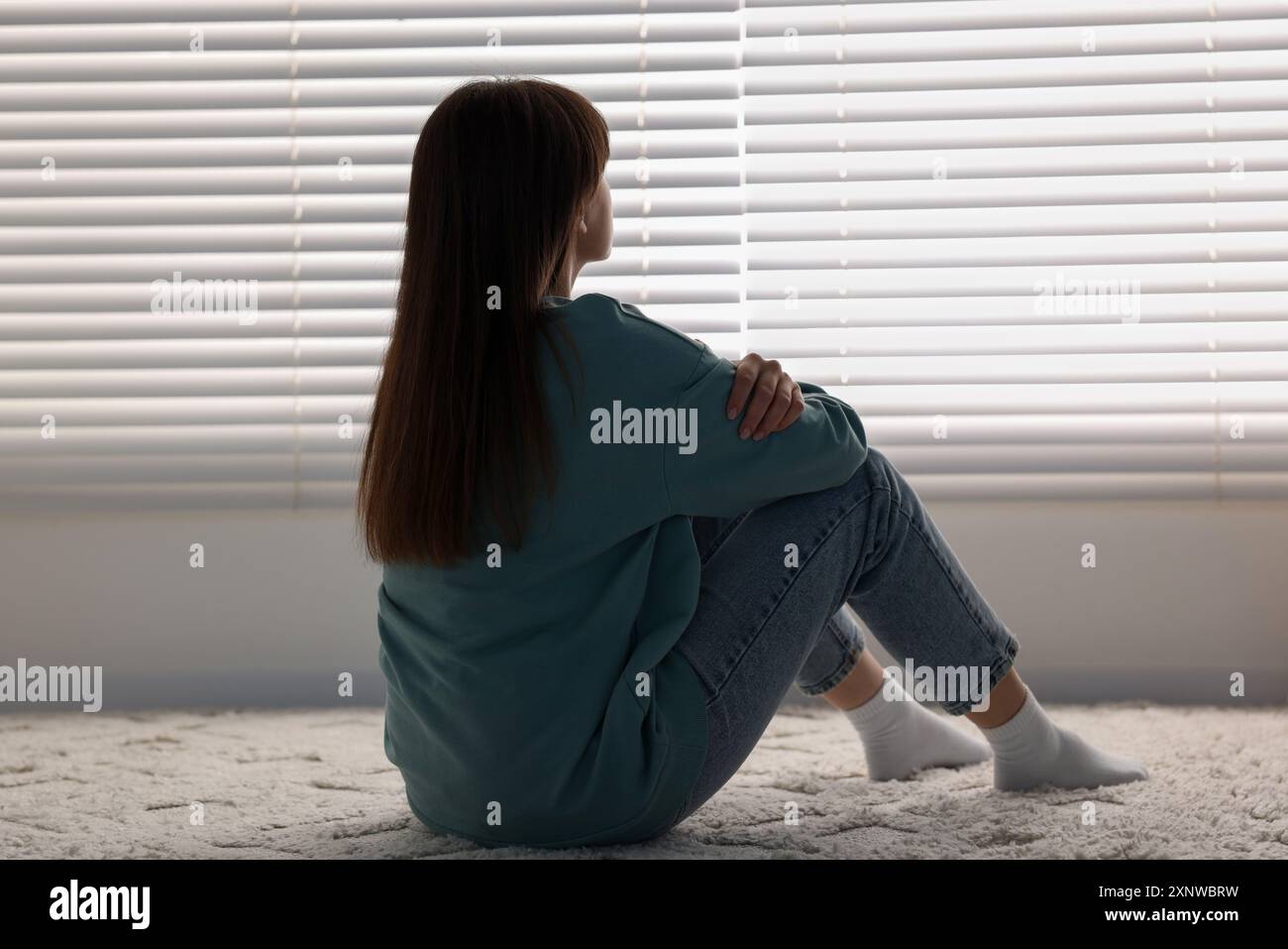 Loneliness concept. Sad woman sitting on floor at home, back view Stock ...