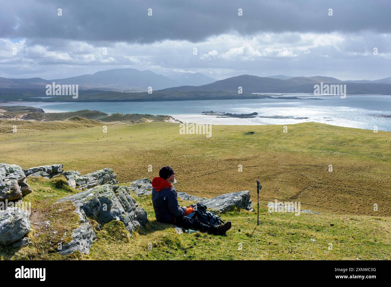 A walker looking across the Kyle of Durness from Faraid Head, near ...