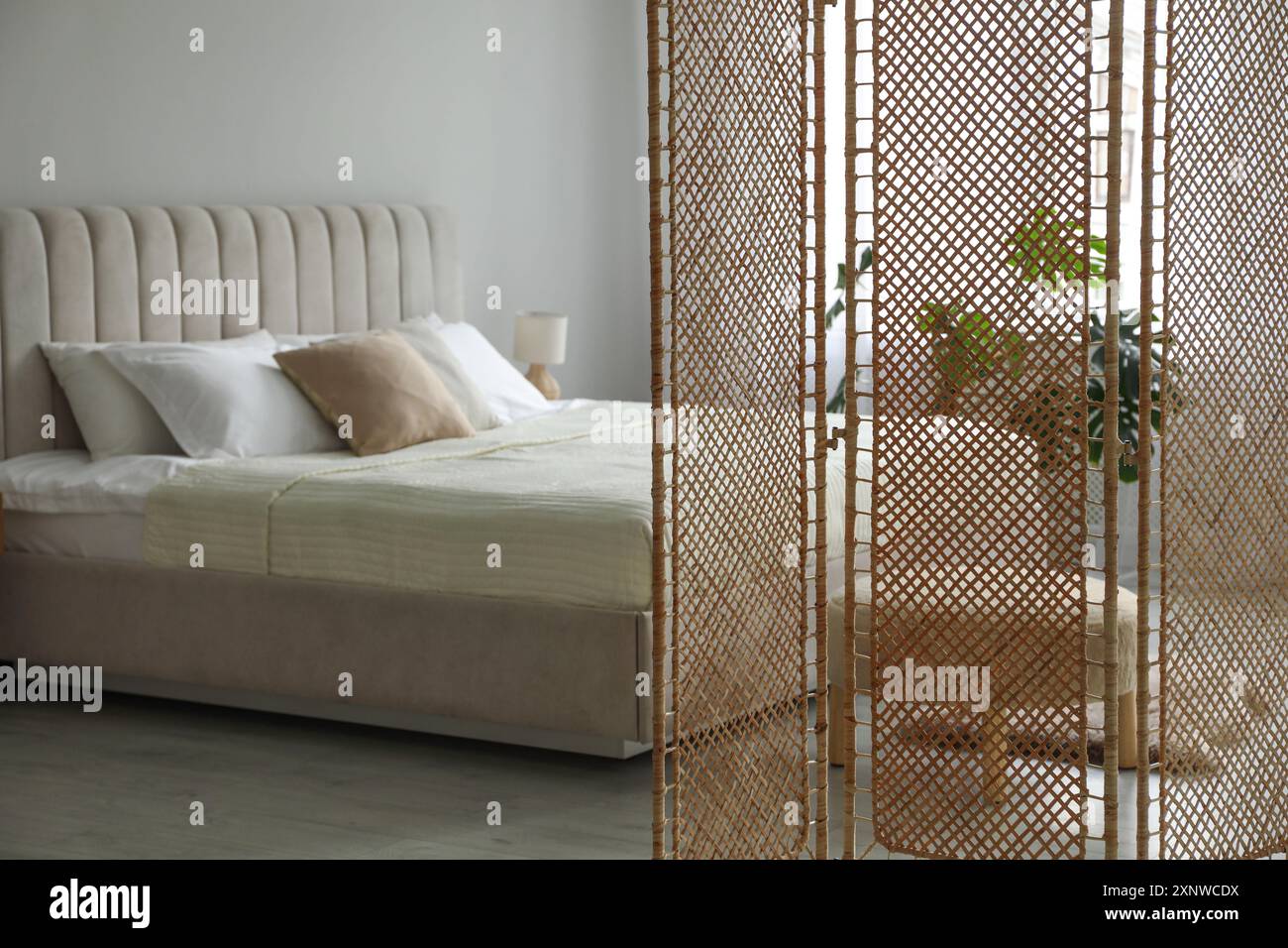 Folding screen and comfortable bed in bedroom. Interior design Stock ...