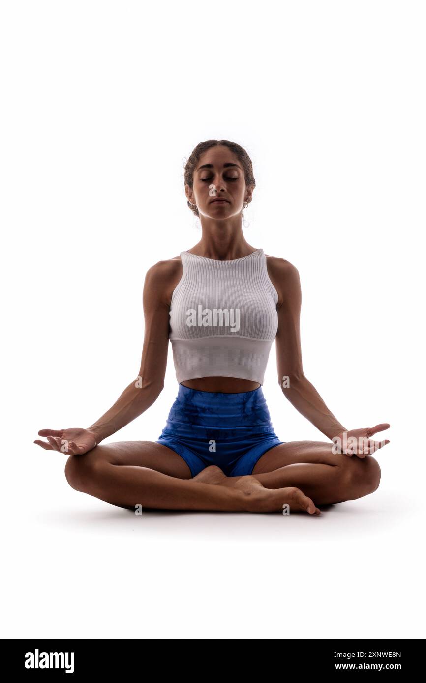 Woman demonstrating lotus position in hi-res stock photography and ...
