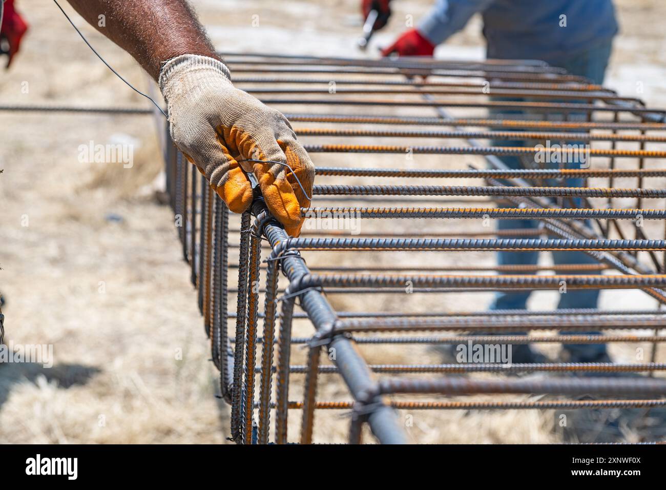 Workers use steel lacing wire to attach steel bars to reinforcing bars ... Workers use steel lacing wire to attach steel bars to reinforcing bars ...