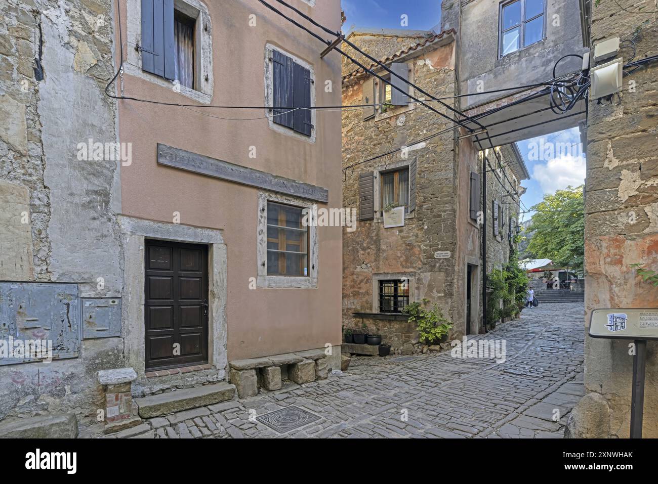 A brick paved courtyard leading to two grand old apartment buildings ...