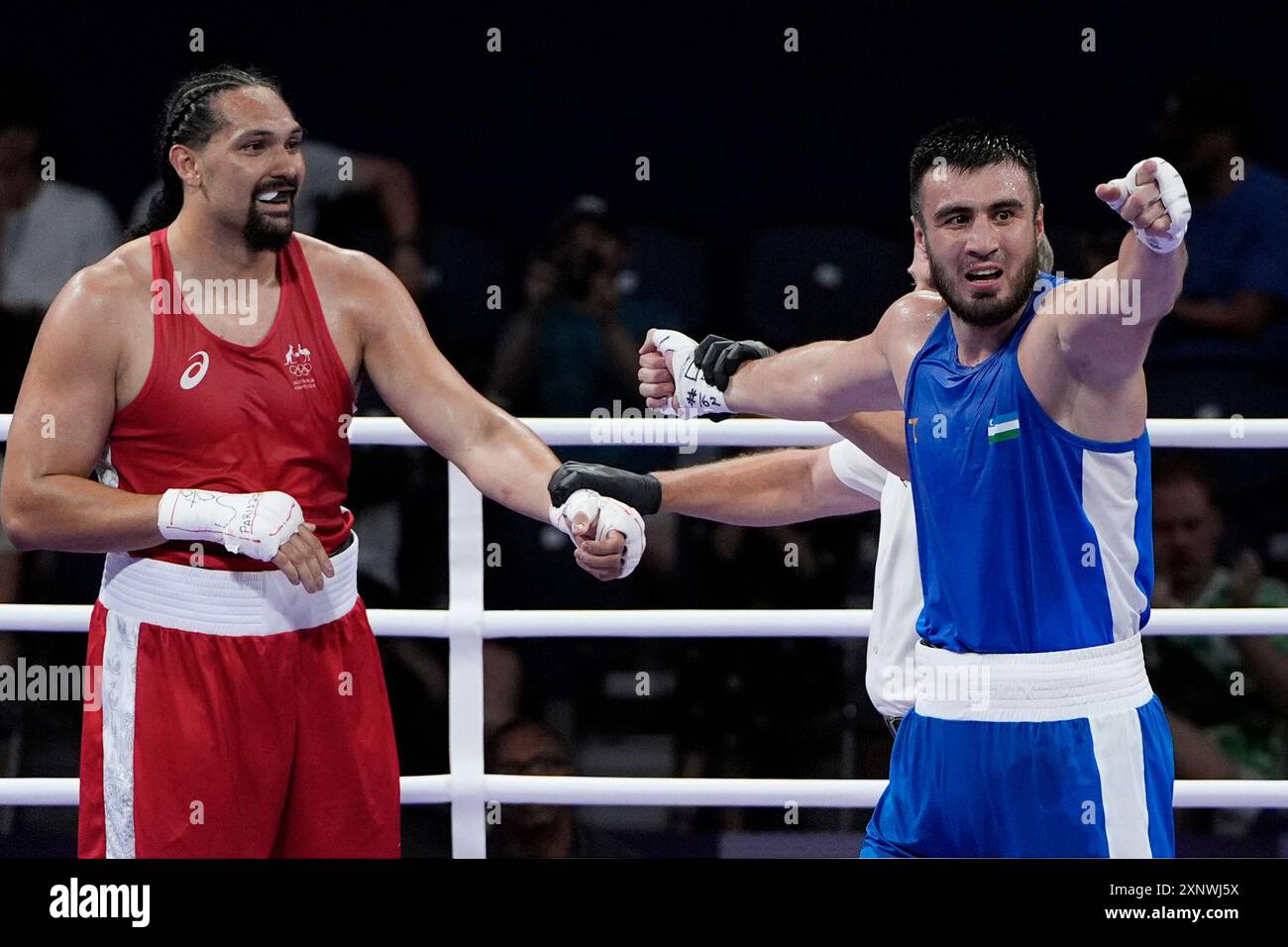 Uzbekistan's Bakhodir Jalolov, right, celebrates after defeating ...