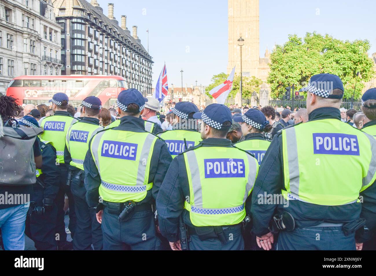 London, UK. 31st July 2024. Police in riot gear face off with ...