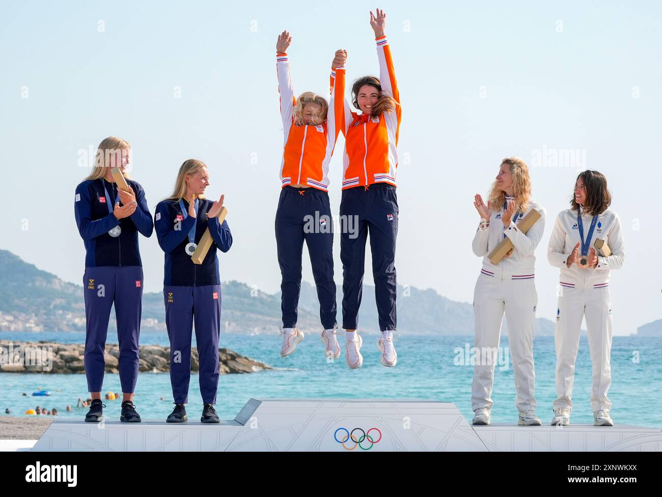 Netherlands' Odile van Aanholt, center left and Annette Duetz, jump in ...