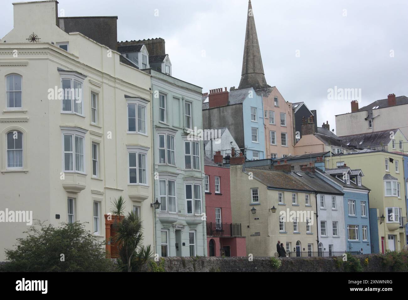 Pastel-coloured houses around the harbour in Tenby, South Wales, UK ...