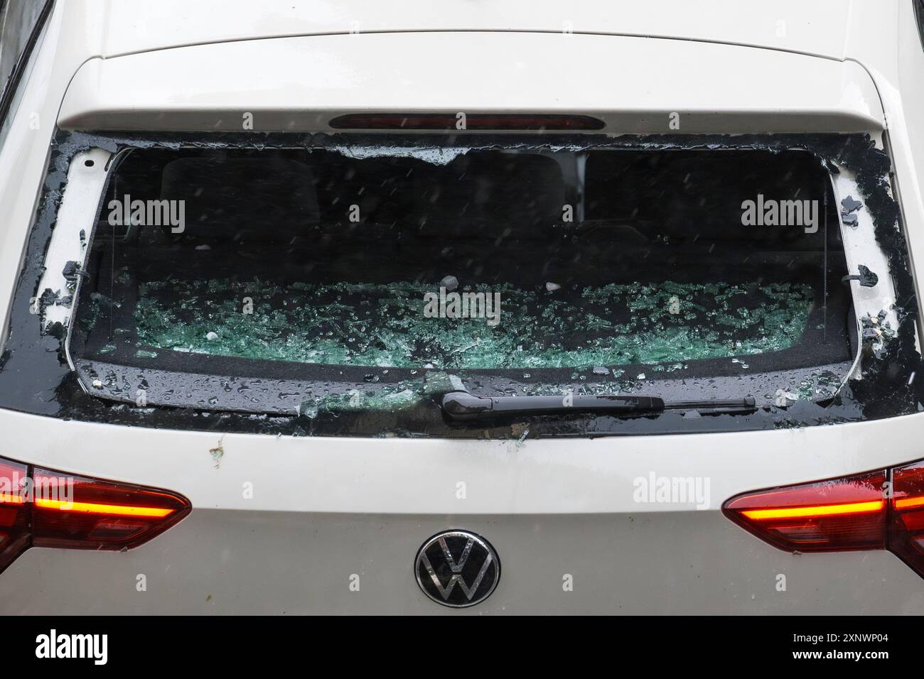 The rear window of a Volkswagen Polo car damaged by hail is seen after ...