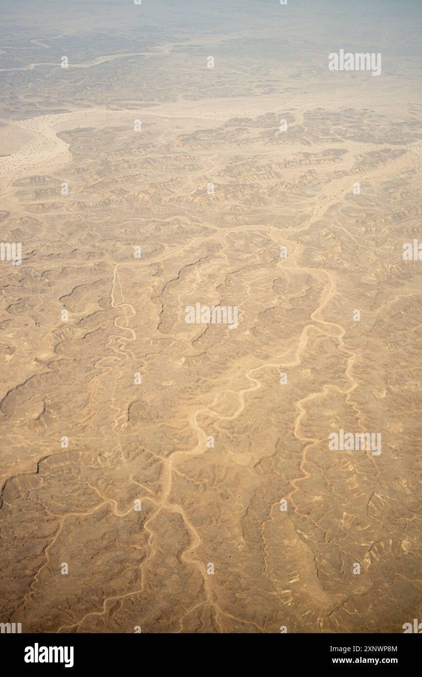 An aerial photograph showcasing the vast, arid desert landscape in Oman ...