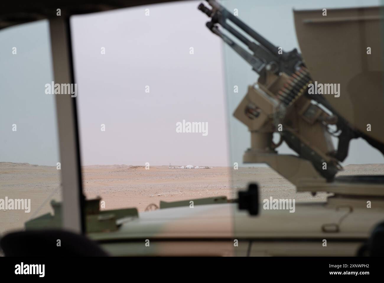 A focused perspective from inside an armored vehicle looking out onto ...