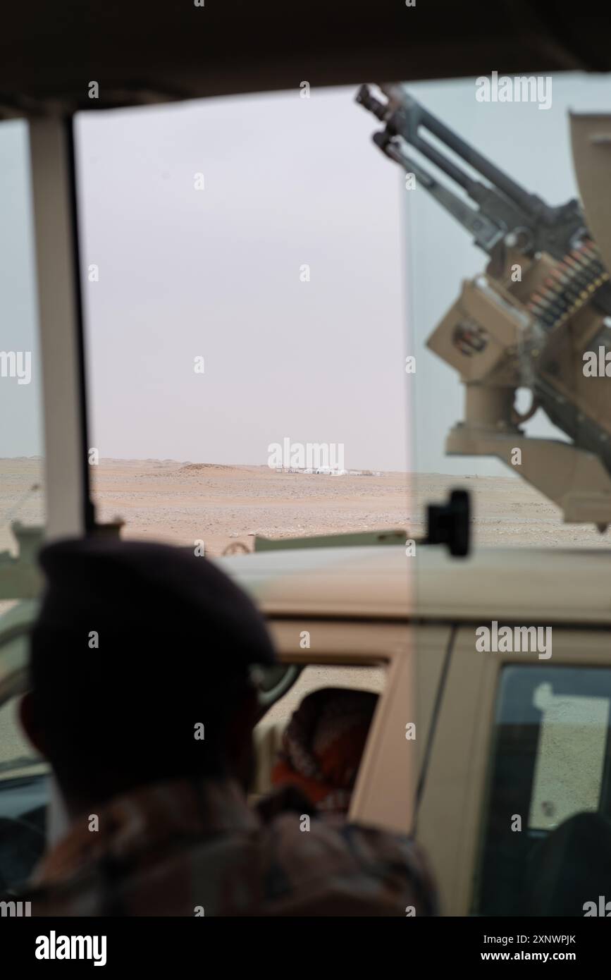 Military personnel are seen inside a vehicle with a mounted weapon ...