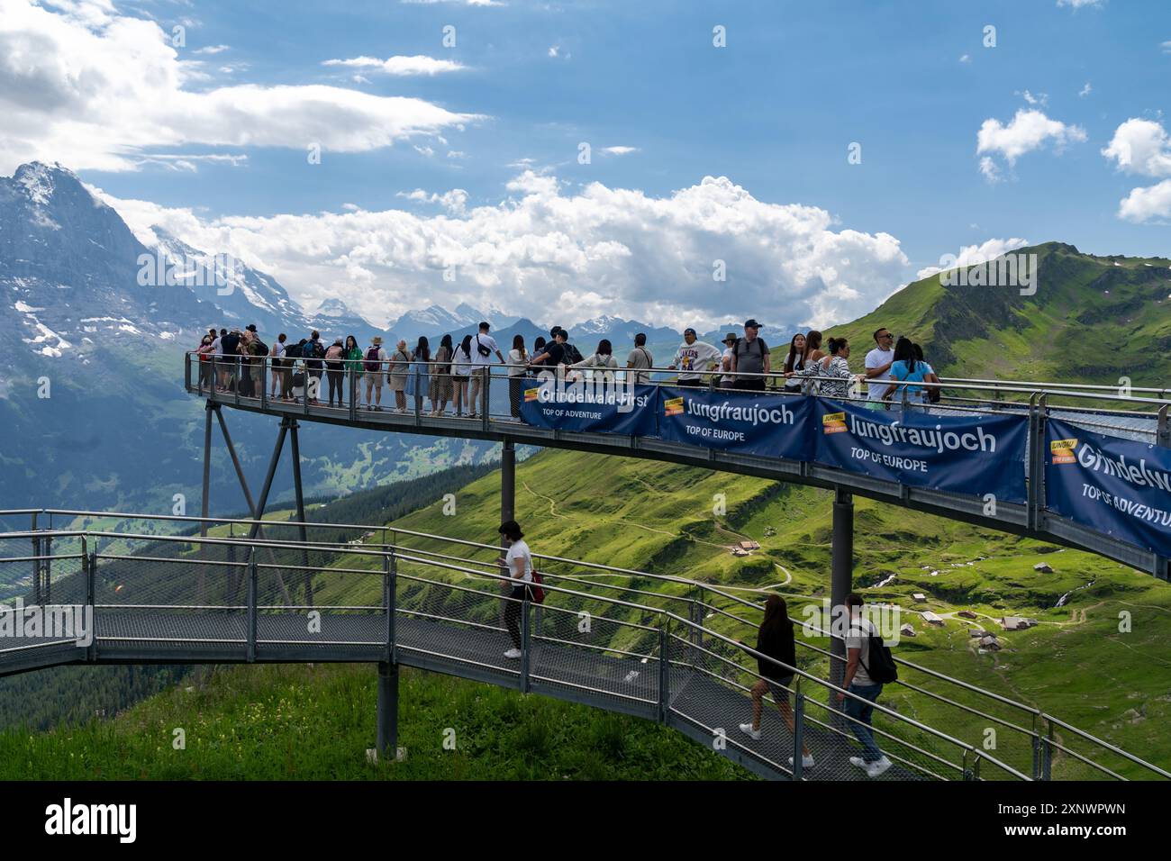 Grindelwald, Switzerland - July 20, 2024: Tourists wait in line to take ...