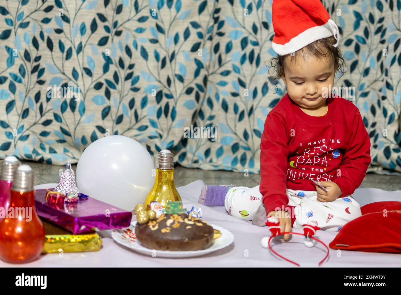 cute infant enjoying Christmas eve celebration at home at night from ...