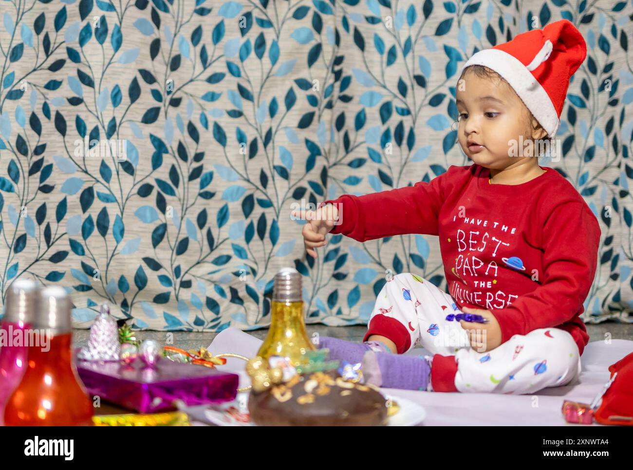 cute infant enjoying Christmas eve celebration at home at night from ...