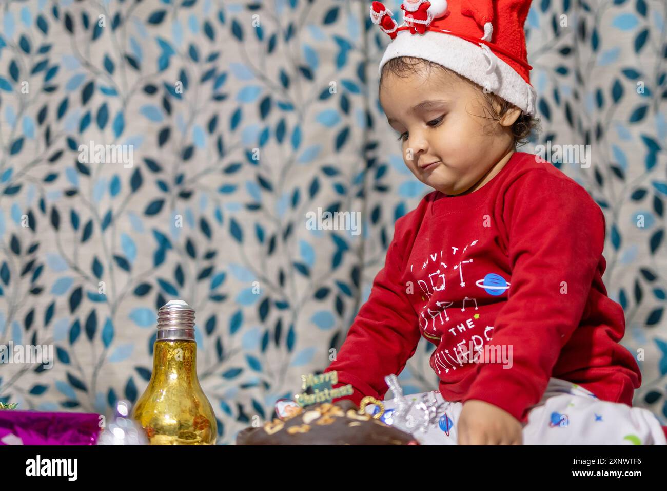 cute infant enjoying Christmas eve celebration at home at night from ...