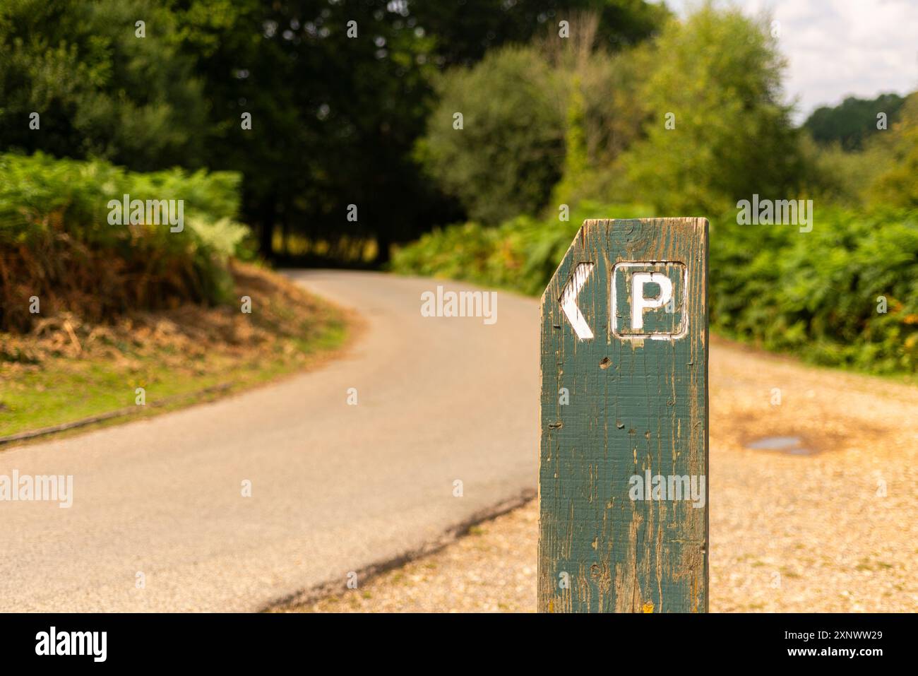 Car park direction sign and rural road, New Forest, Hampshire, England ...
