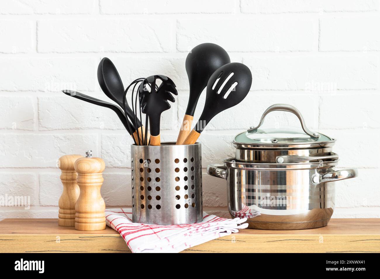 Modern Kitchen with wooden table, kitchen utensils, cooking pots at ...