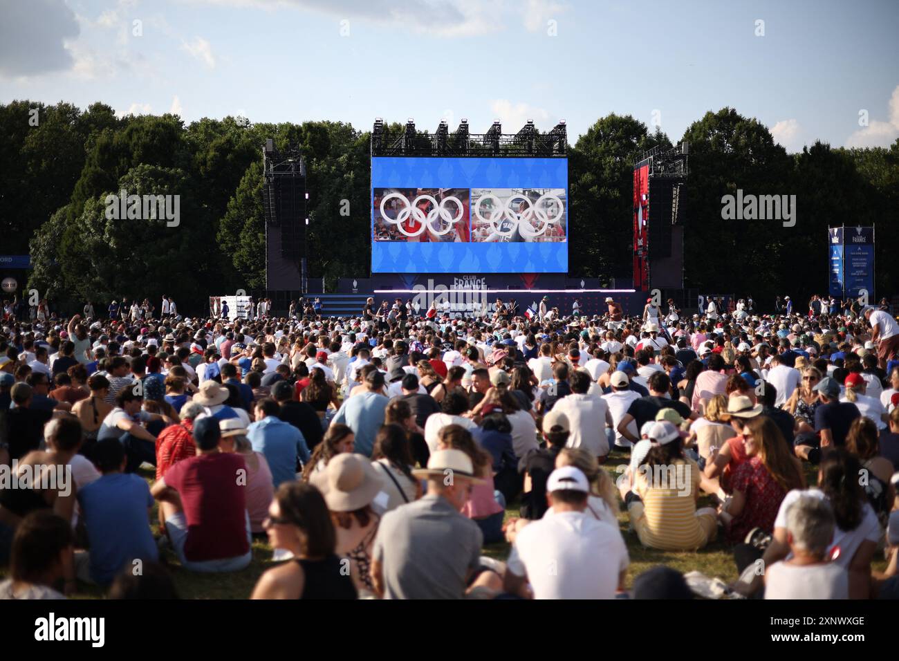 Supporters in front a screen outside in the Fan Zone at the Club France ...