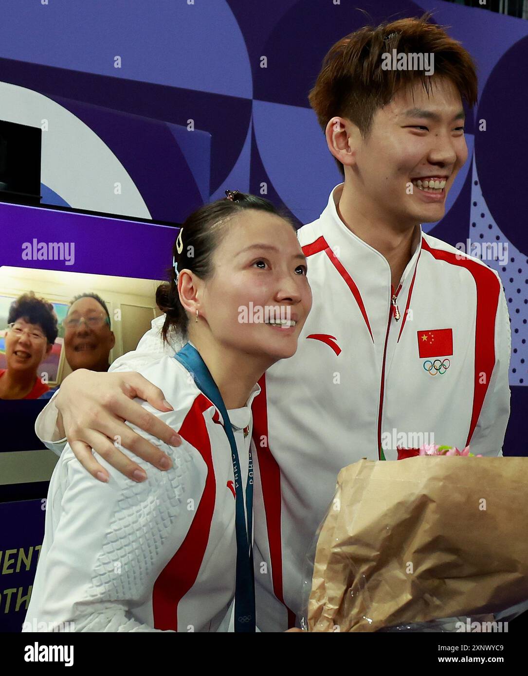 Paris, France. 2nd Aug, 2024. Chinese badminton player Liu Yuchen (R) and his fiancee, gold ...