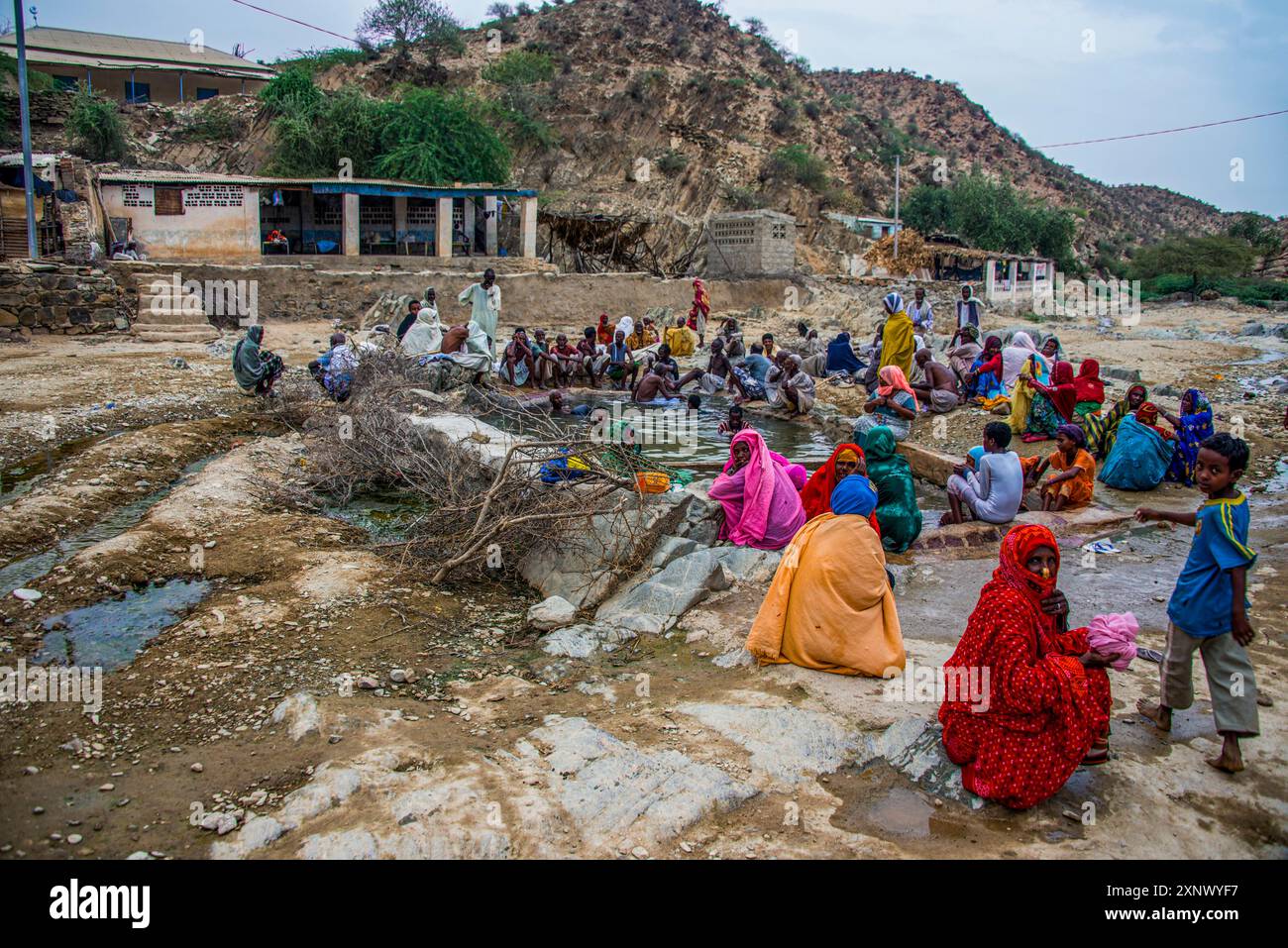 Men and women sitting in a hot spring in the lowlands of Eritrea ...