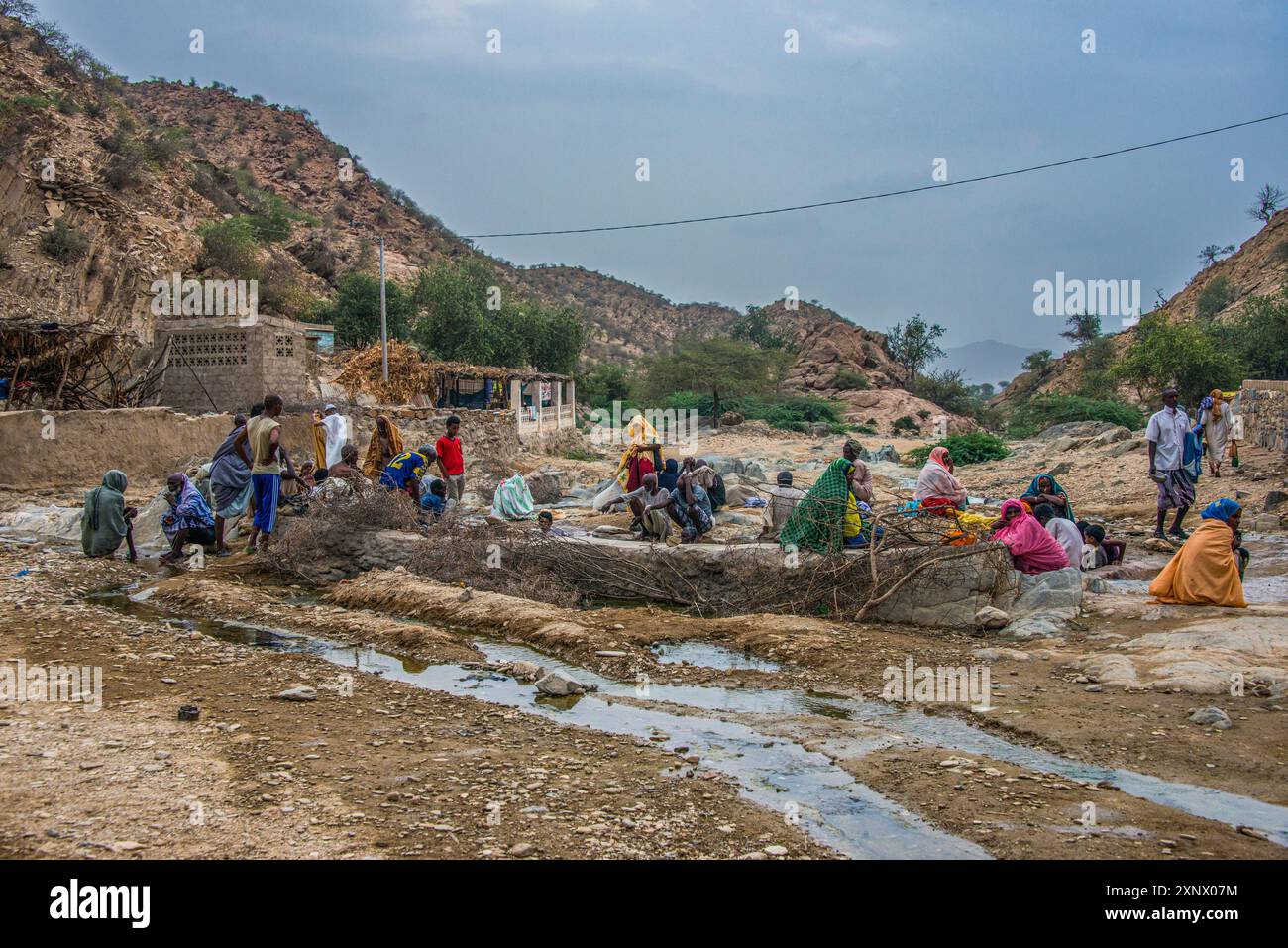 Men and women sitting in a hot spring in the lowlands of Eritrea ...